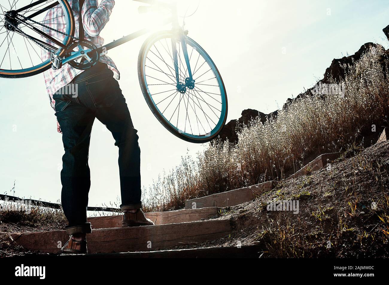 man carrying bike up steps Stock Photo - Alamy