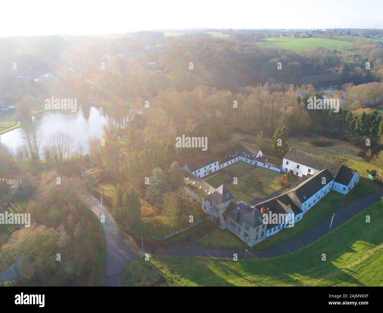 Aerial view of little farm castle surrounded by agriculture farmland et ...