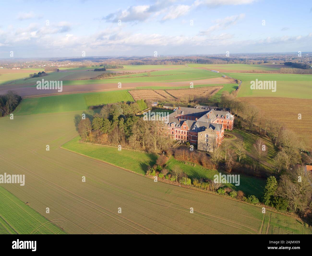 Aerial view of little farm castle surrounded by agriculture farmland et ...