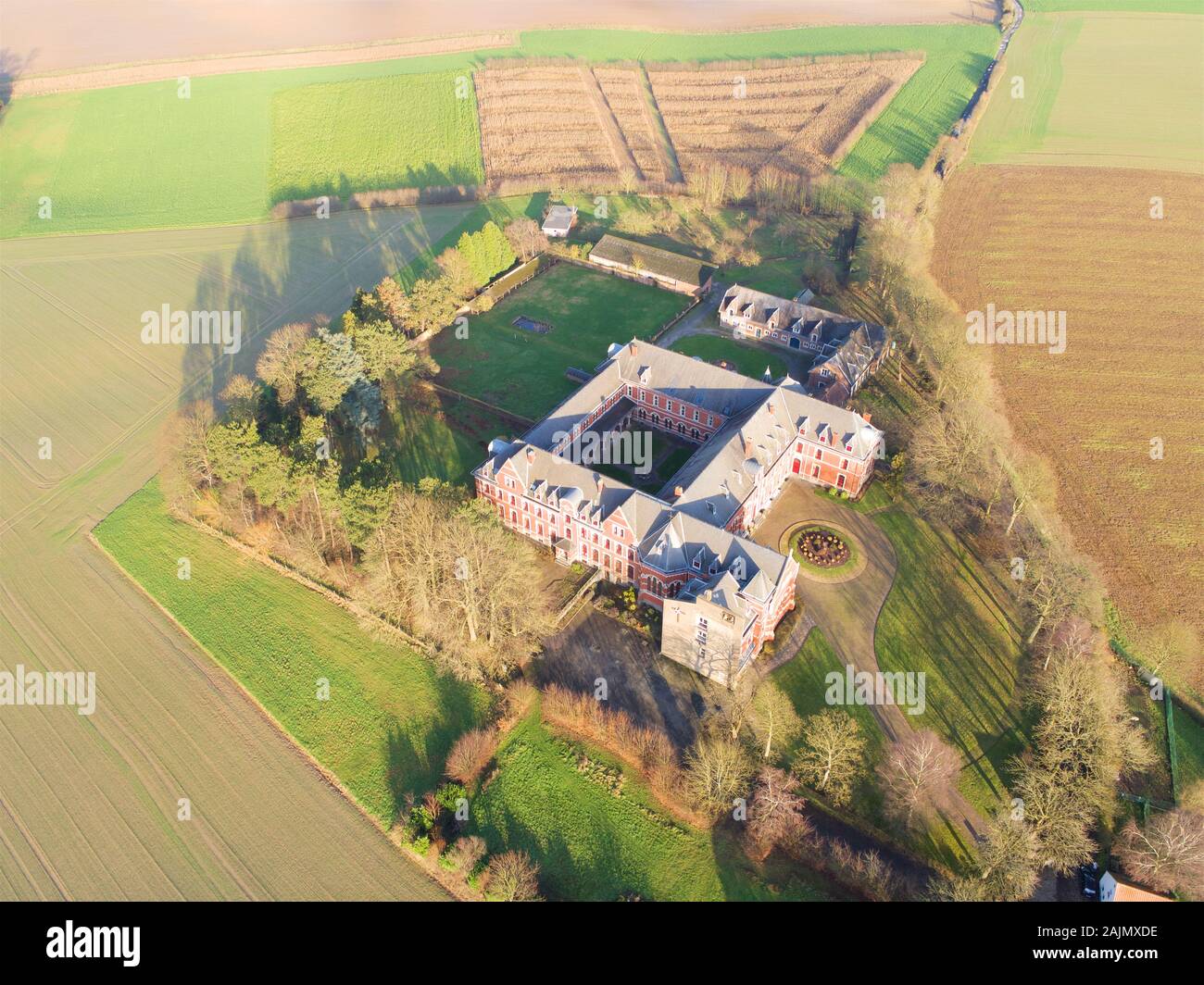 Aerial view of little farm castle surrounded by agriculture farmland et ...