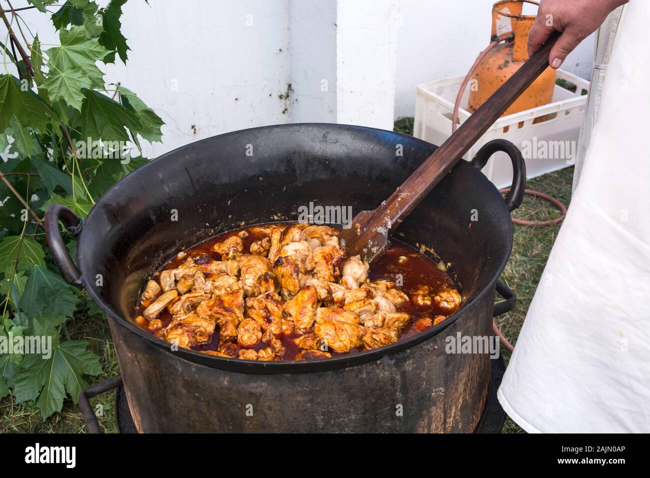 In a traditional competition, chicken stew is cooked in a cauldron ...