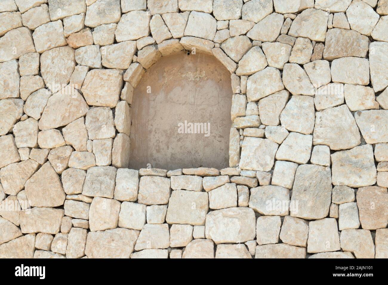 Dry Stone wall with inset arch in the town of Cala Llonga, in Ibiza ...