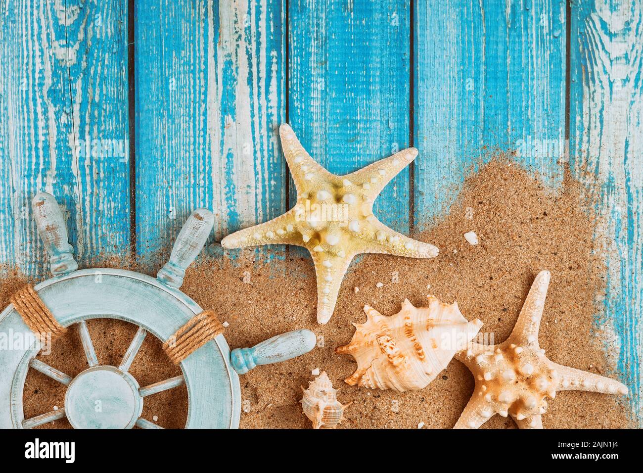 Summer travel with sailor's captain's wheel starfish and seashell on ...