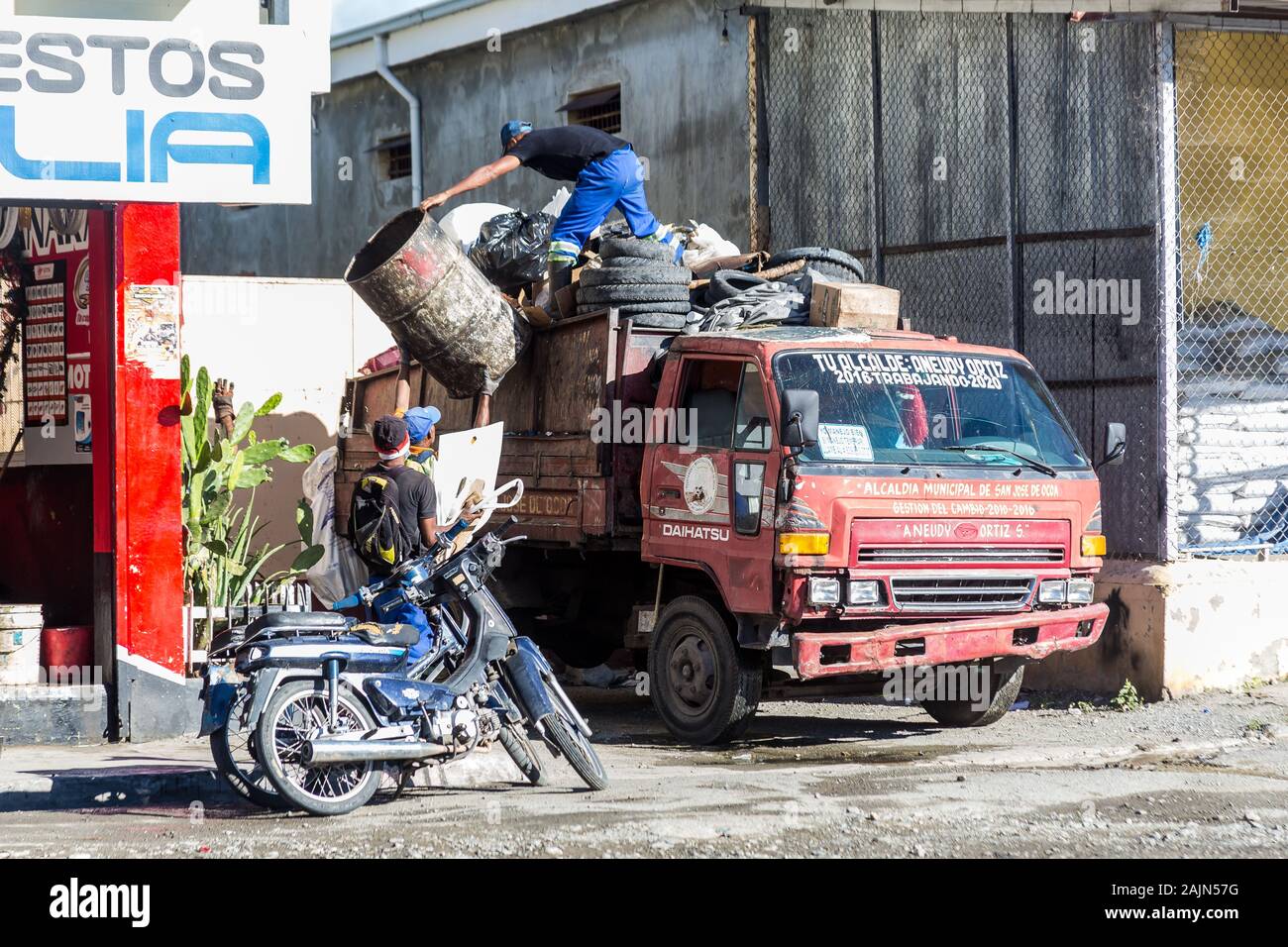dramatic image of garbage workers on a garbage truck dumping trash cans ...