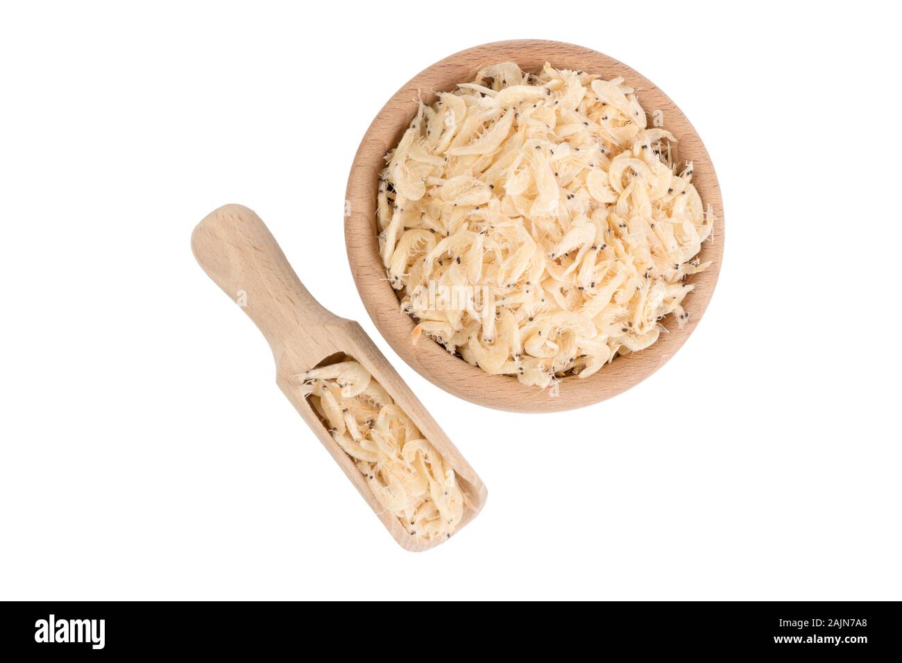 dried prawns in wooden bowl and scoop isolated on white background ...