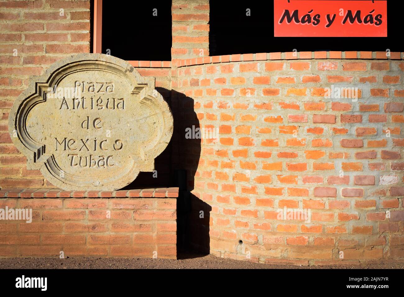 Off centered view of A traditional hand carved stone sign for the Plaza ...