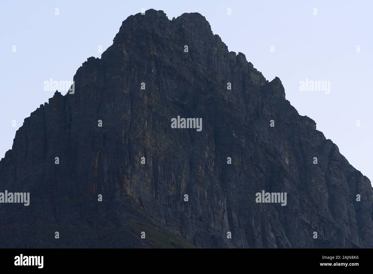 Jagged Cliff in Glacier against dim sky Stock Photo - Alamy