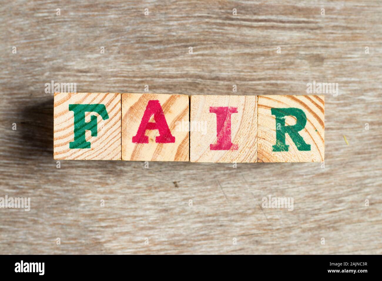 Letter block in word fair on wood background Stock Photo - Alamy