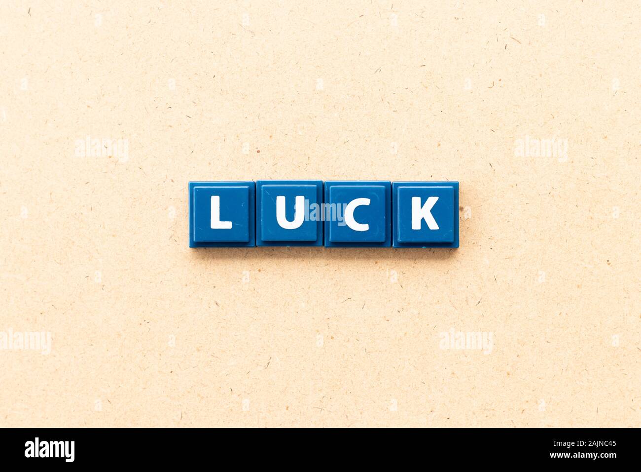 Tile letter in word luck on wood background Stock Photo - Alamy
