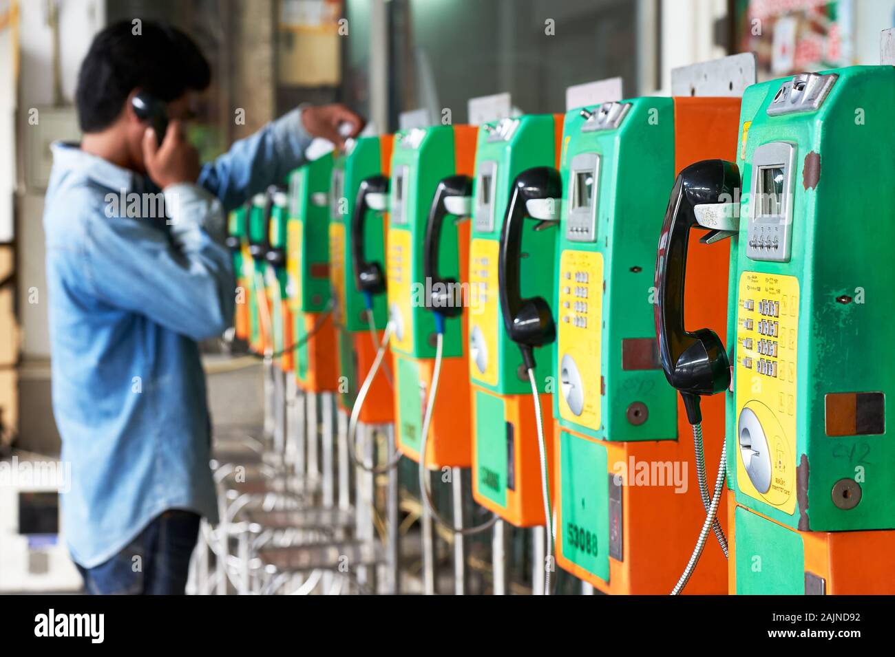 Bangkok, Thailand: A young man is doing a phone call on one of many ...