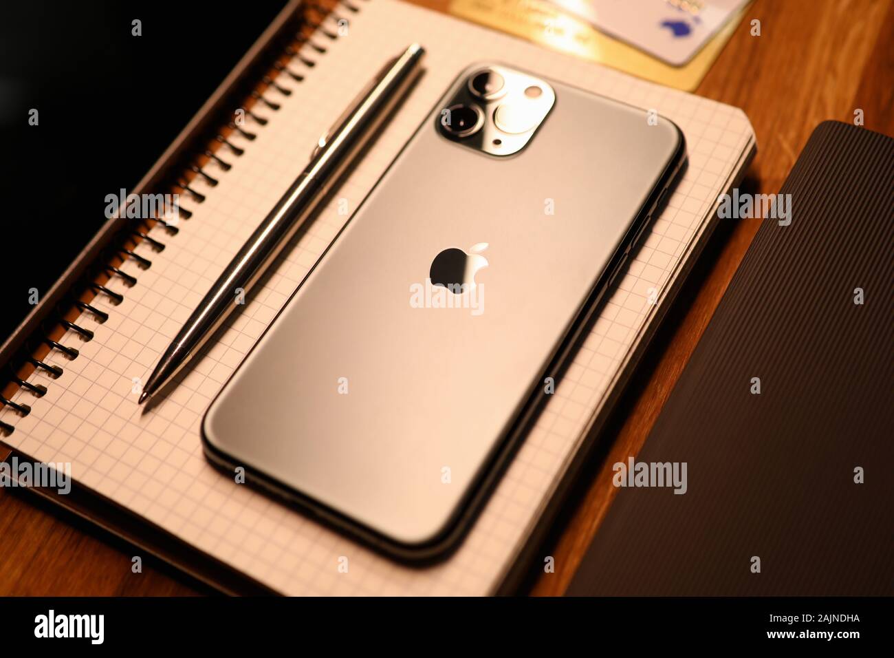 Apple iphone pro with silver pen on notebook Stock Photo - Alamy