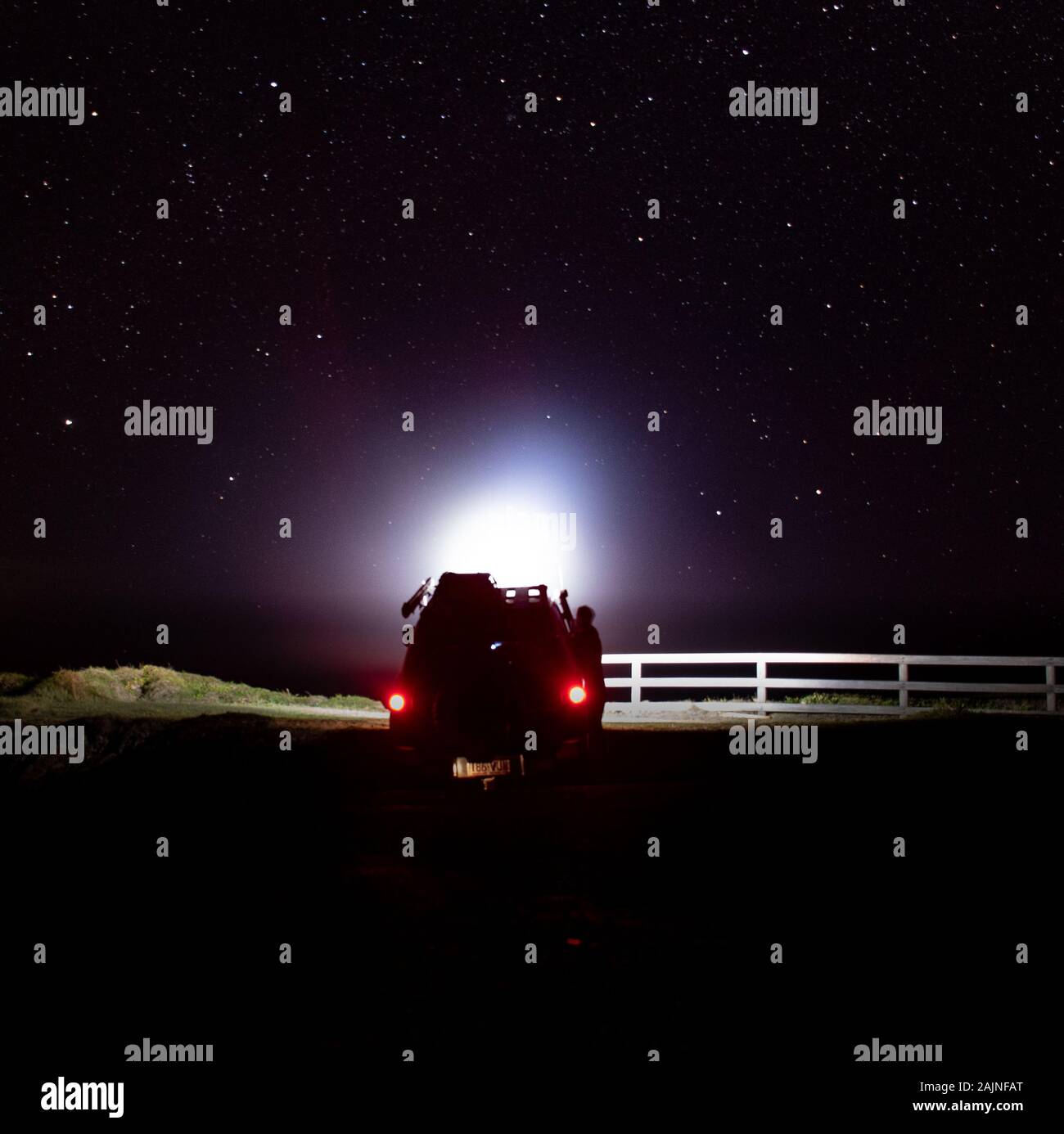 a car lights up the night with bright lights Stock Photo - Alamy
