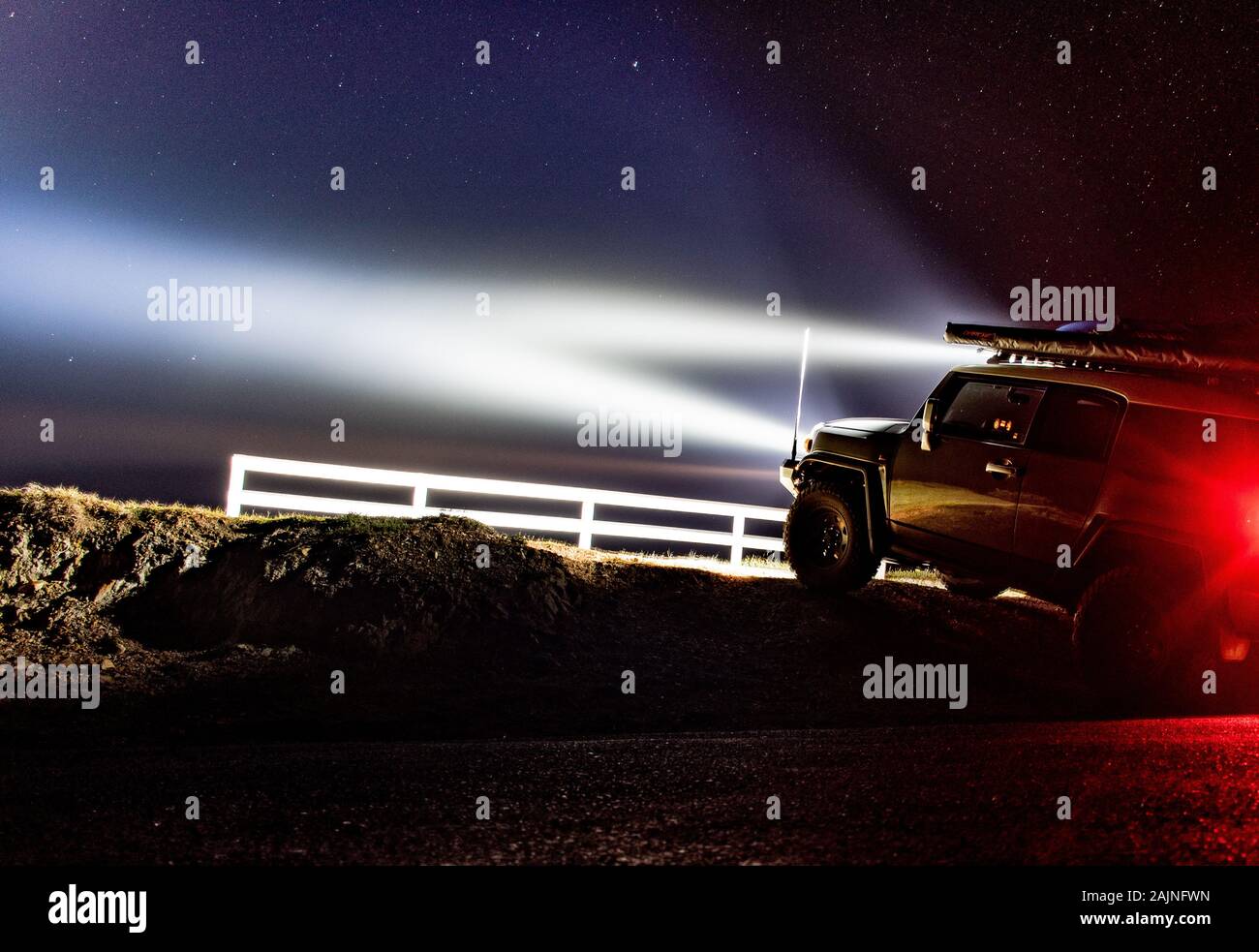 a car lights up the night with bright lights Stock Photo - Alamy