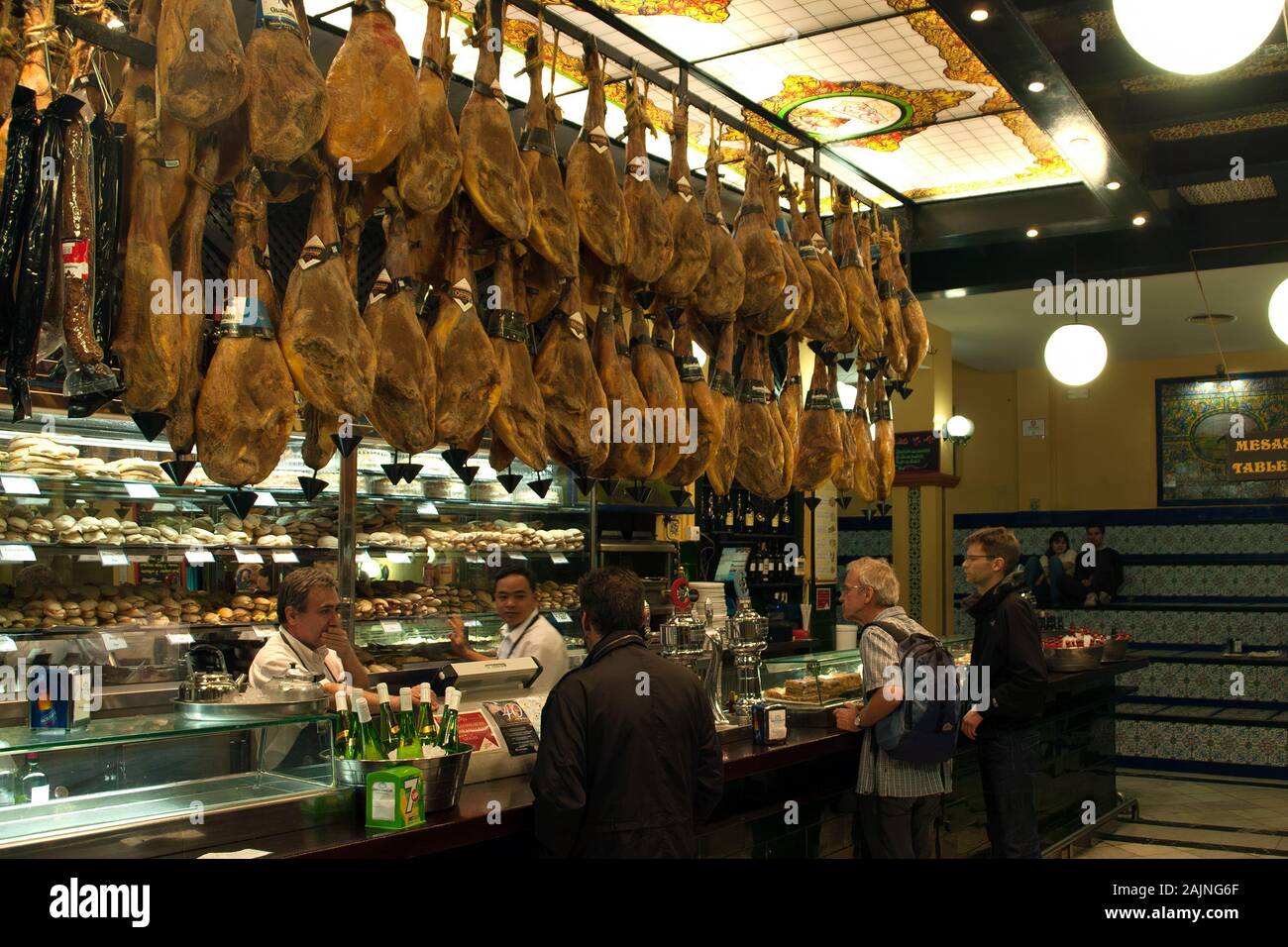 Seville Spain, people being served in local jamoneria Stock Photo - Alamy