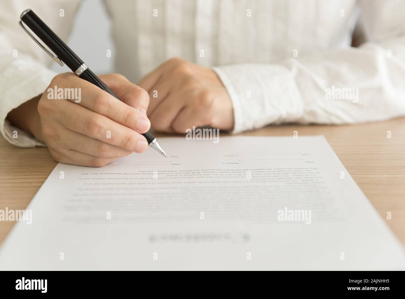 hand holding a pen to sign approval about to sign a letter Stock Photo ...