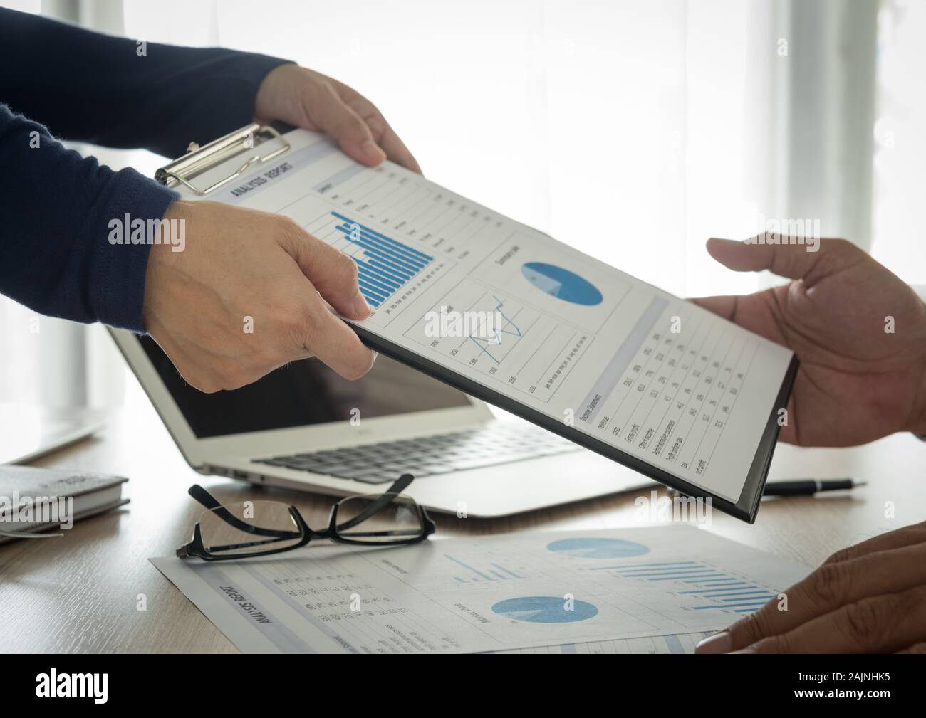 Financial analysts provide summary reports to manager Stock Photo - Alamy