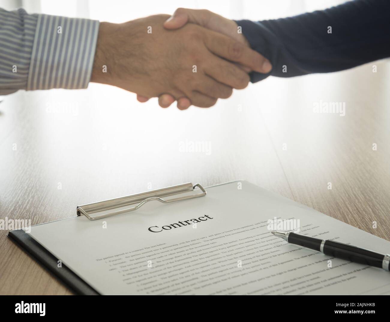 Documents contracting with partners are handshake background. select ...