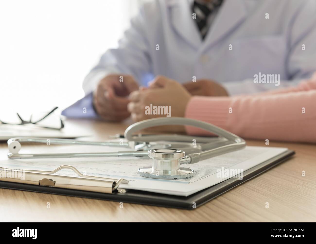 stethoscope and medical documentation with doctor and patient ...