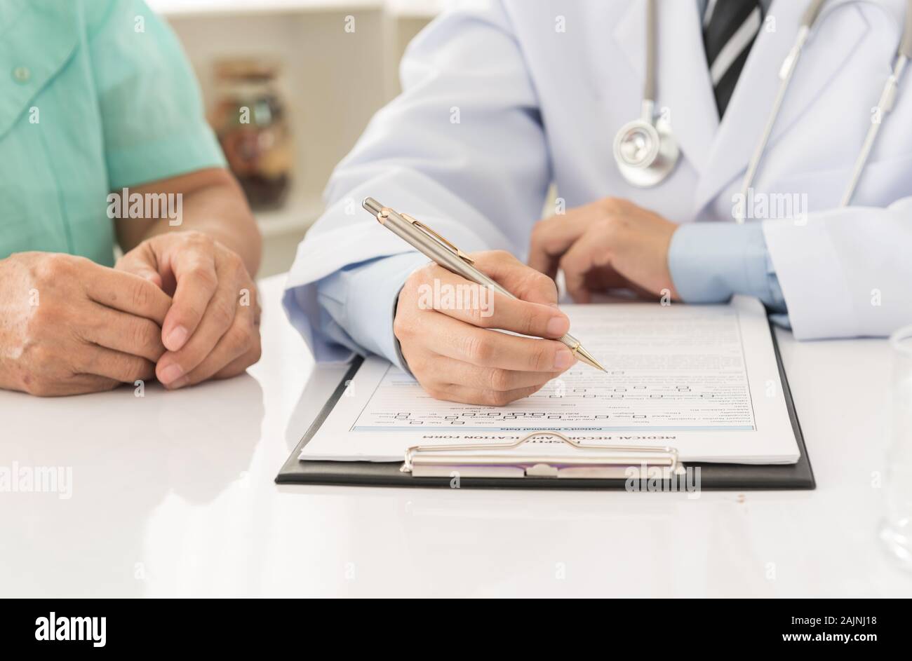 doctor record data on application form while consulting patient Stock ...