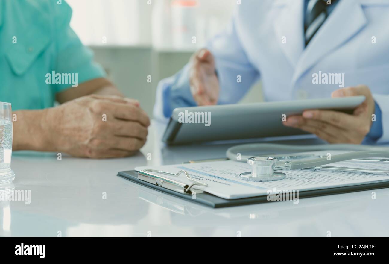 close up stethoscope on application form with doctor and patients in ...