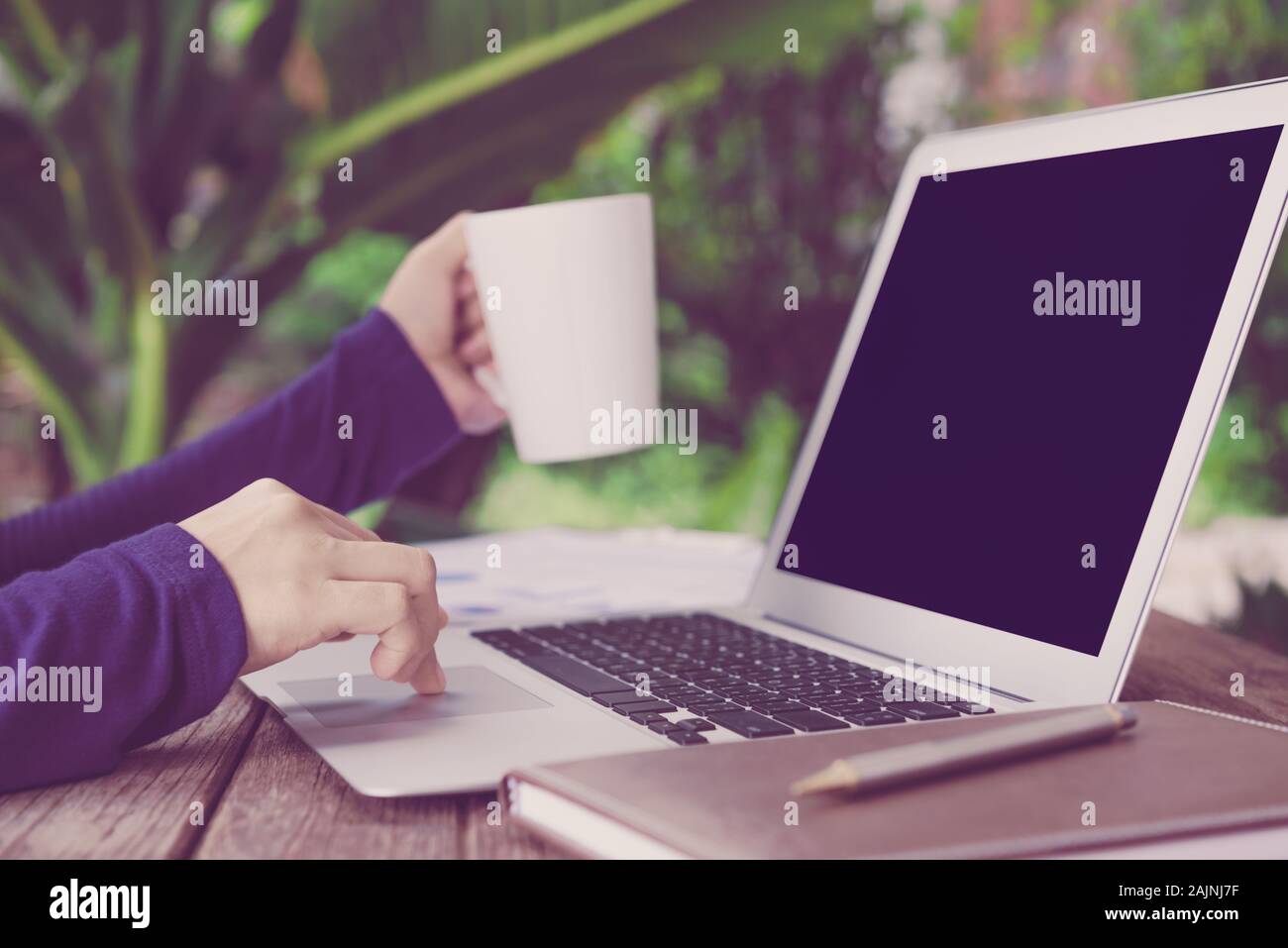 closeup a hand using notebook computer. technology concept , shopping ...