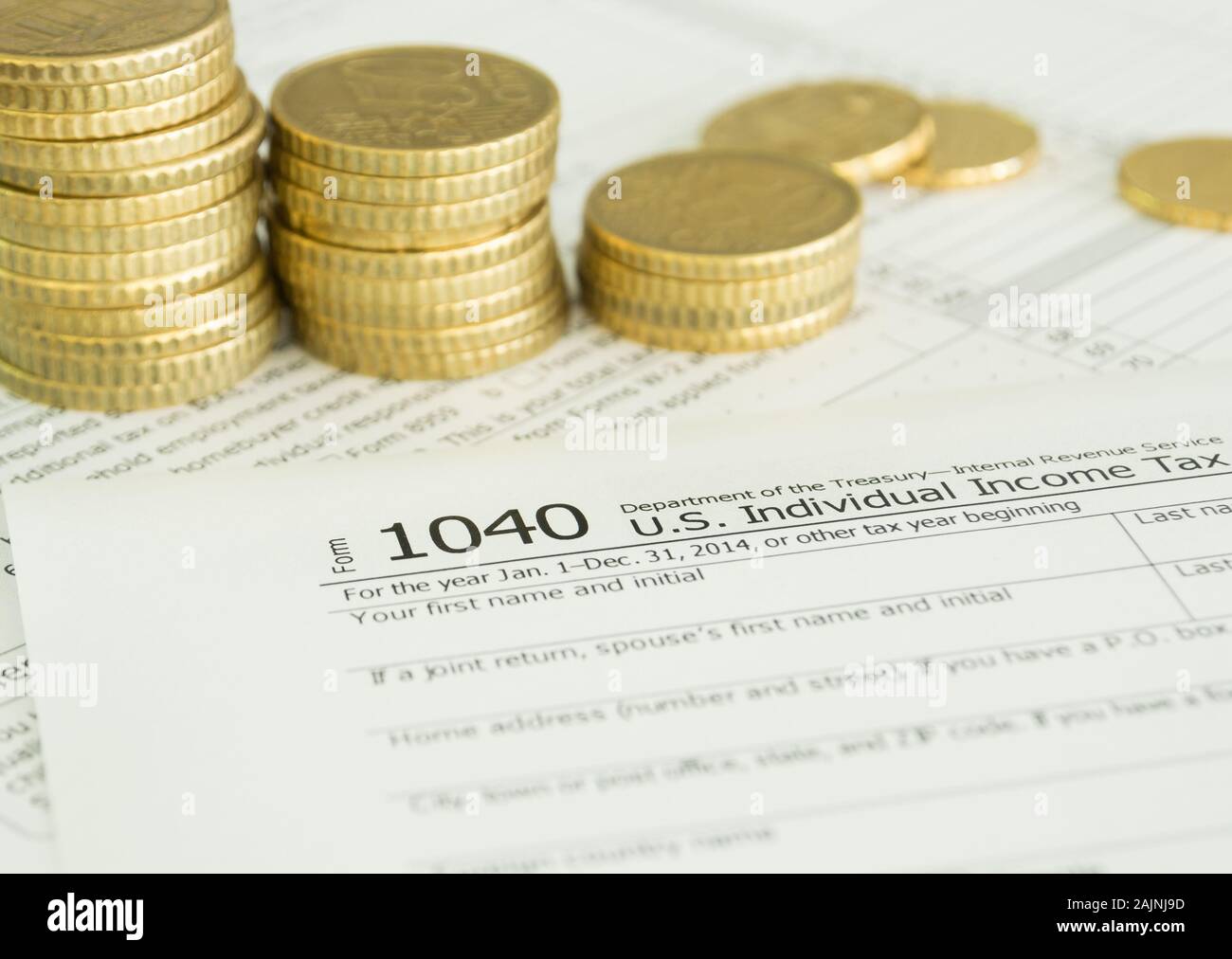 close-up income tax return form with golden coins on desk Stock Photo ...