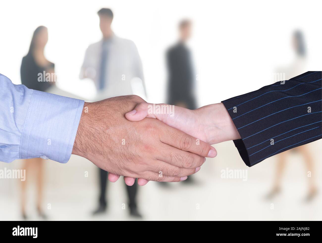 Closeup of a business handshake with office background Stock Photo - Alamy
