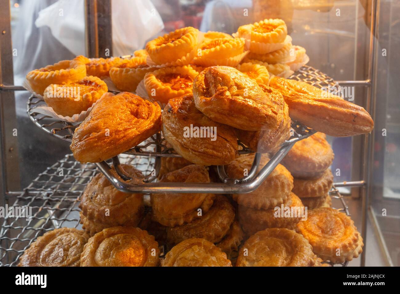 Showcase with puff pastry in a street shop. Photo with shallow depth of ...