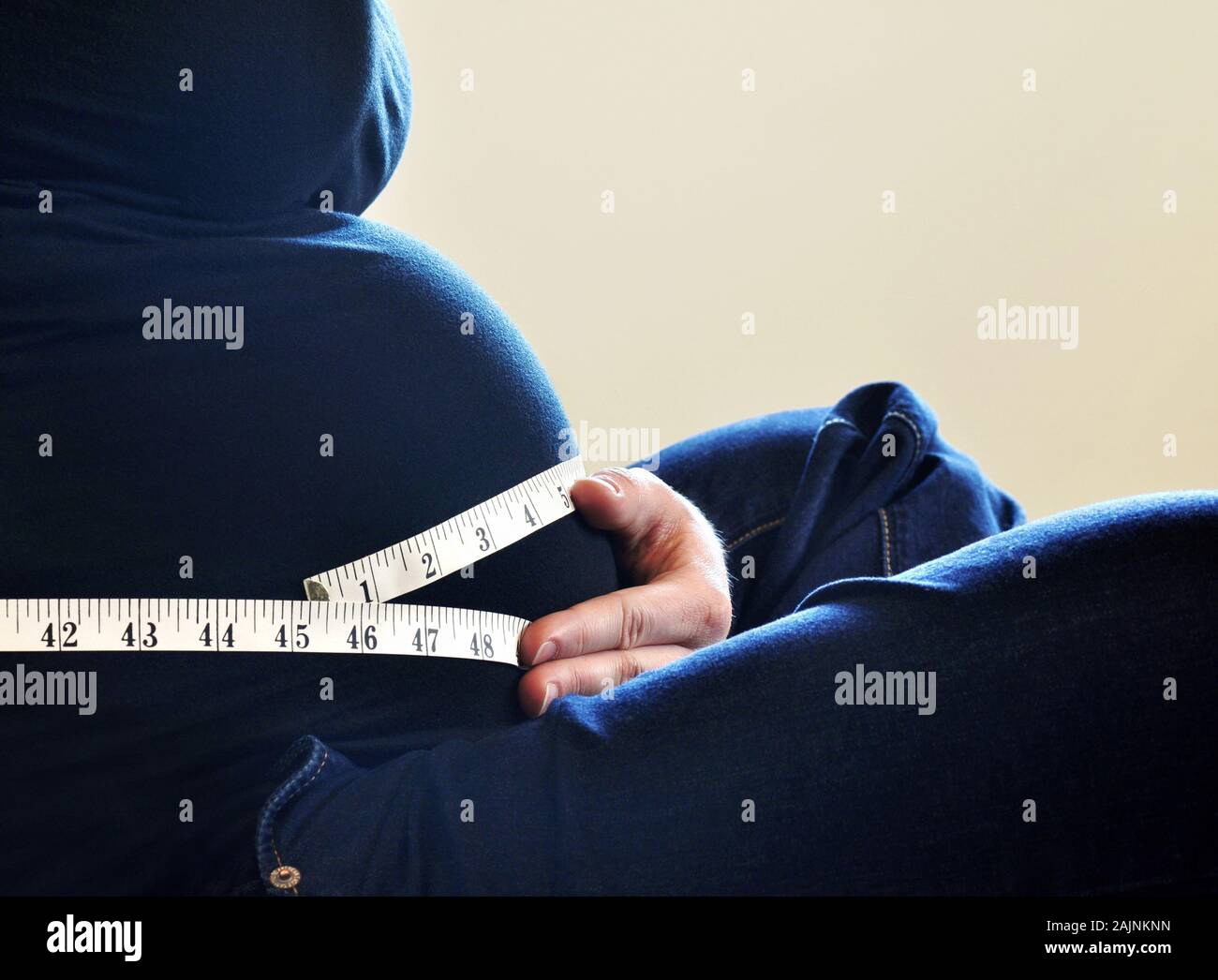 Pregnant woman measuring her belly size Stock Photo - Alamy