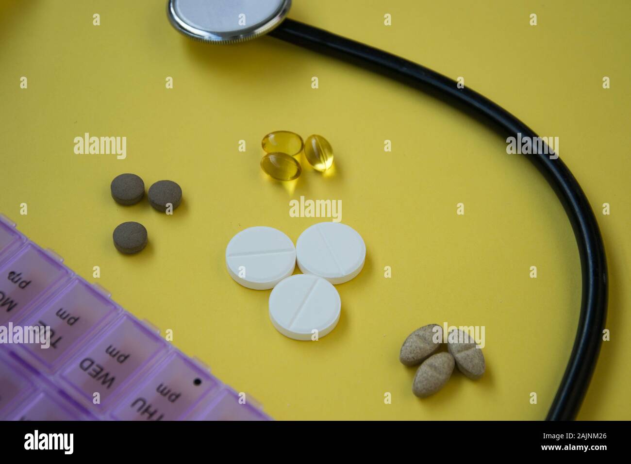 Bunch of pills and capsules, box for storage of drugs and medical ...