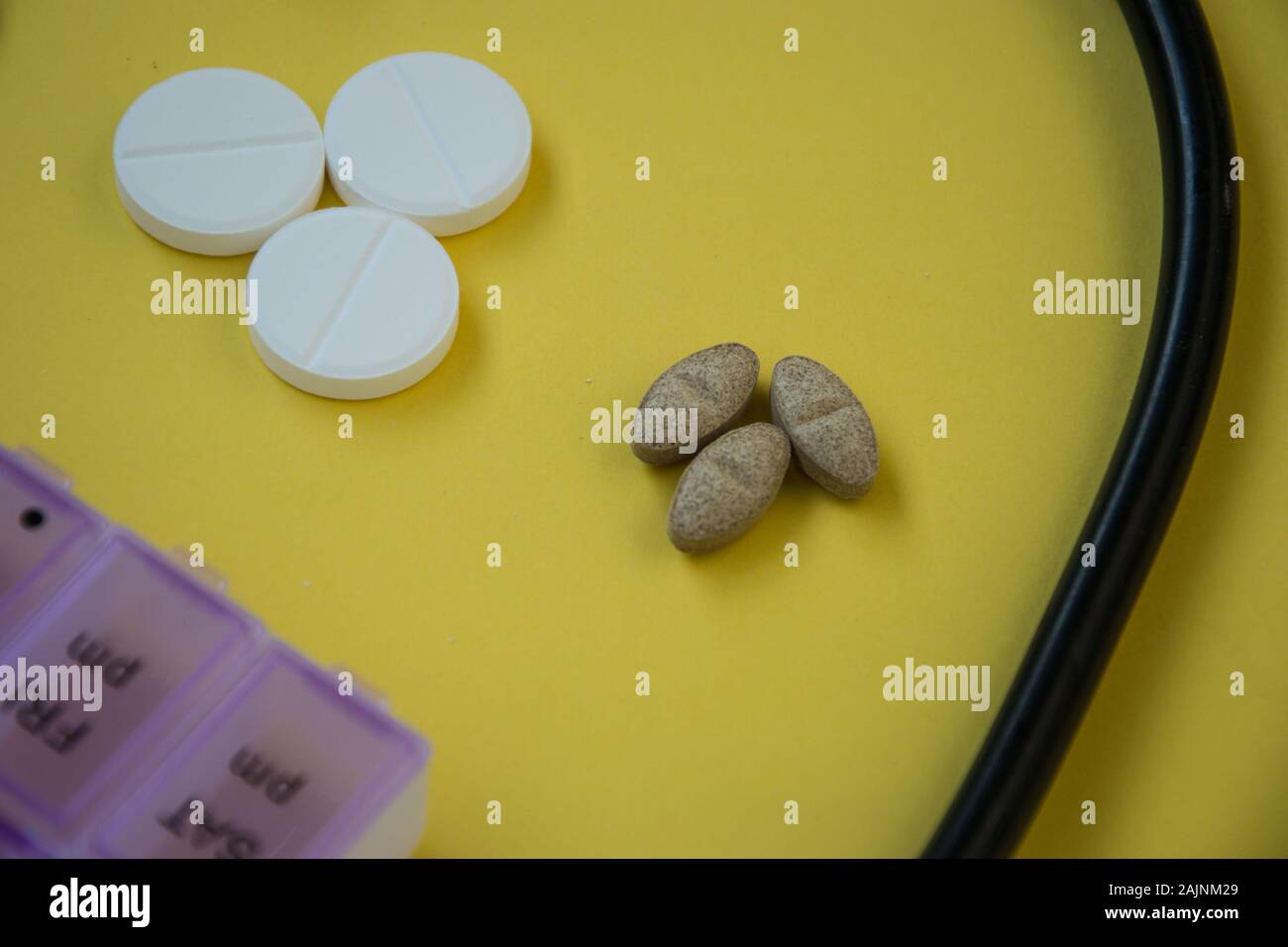 Bunch of pills and capsules, box for storage of drugs and medical ...