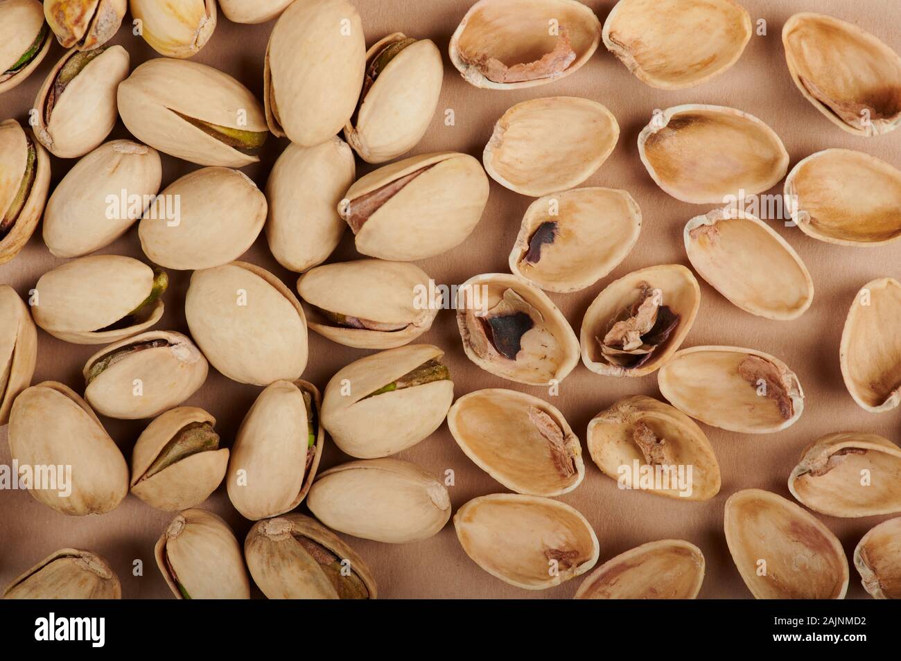 Eating pistachio theme. Empty and full pistachio shells Stock Photo - Alamy