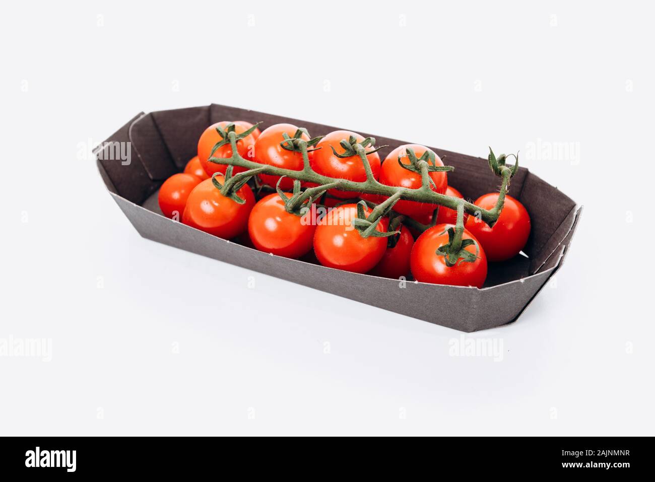 Red tomatoes in a plastic pack. Isolated, white background. White ...
