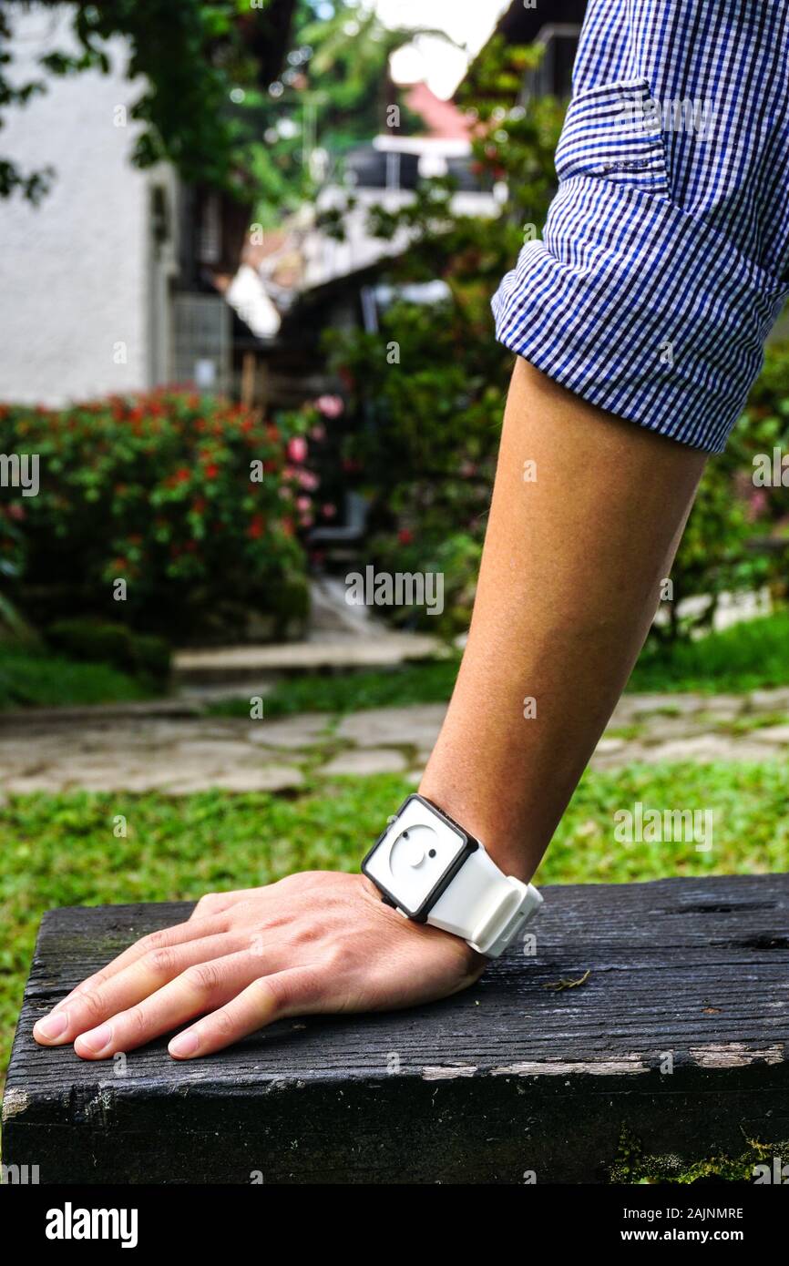 Man hand with white watch in nature background Stock Photo - Alamy