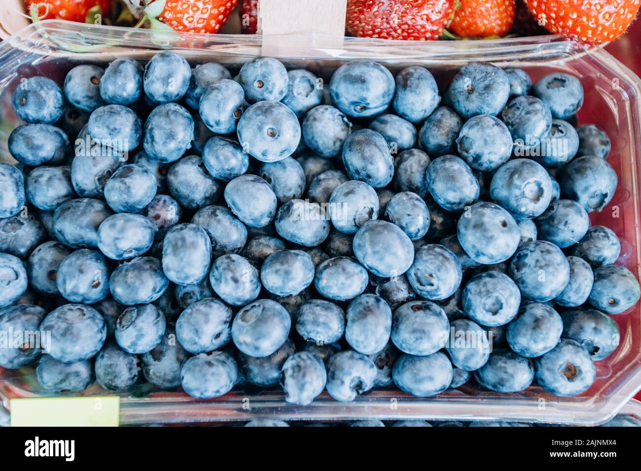Blueberries in clear plastic tray shot from above Stock Photo - Alamy