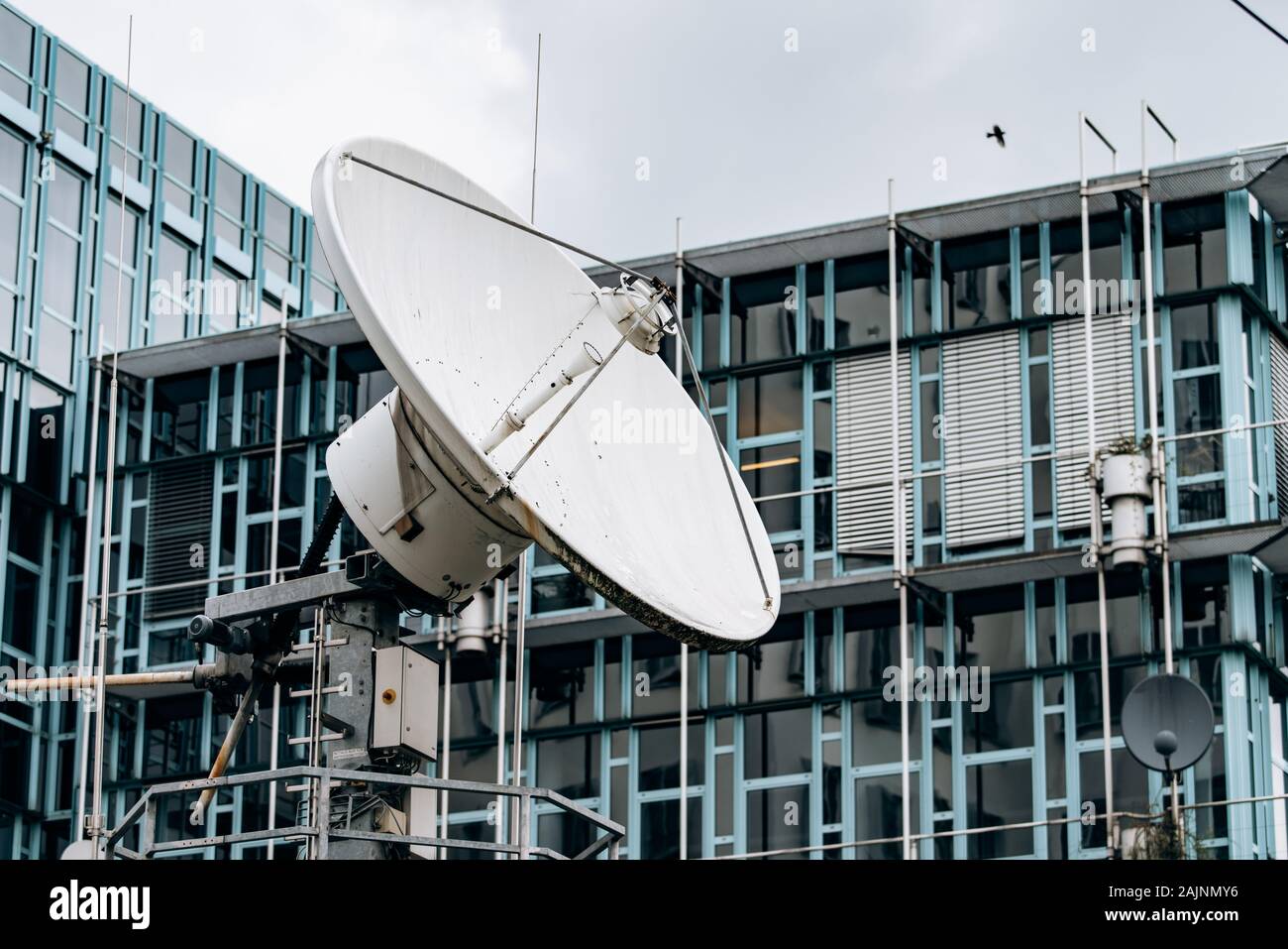 Parabolic satellite dish on the background of the building Stock Photo ...