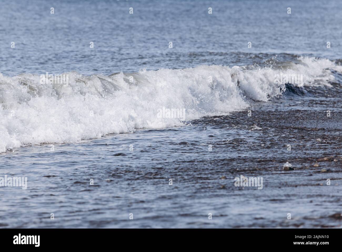 Waves on the beach. A surge of water ashore Stock Photo - Alamy