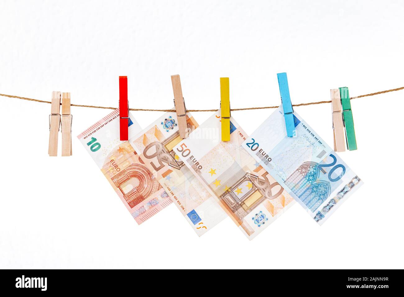 Euro banknotes are attached with clothespins of different colors to a ...