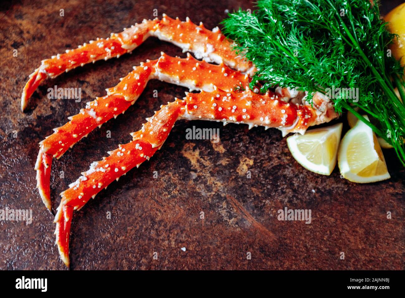 On the table are crab, lemon and herbs. Table of reddish color Stock ...