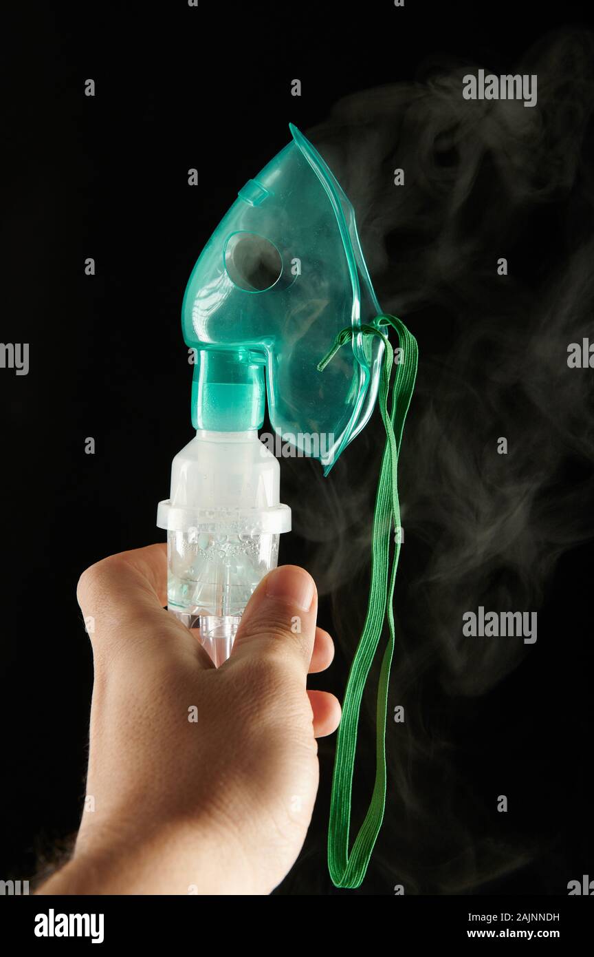 Inhalation mask with steam isolated on black background Stock Photo - Alamy