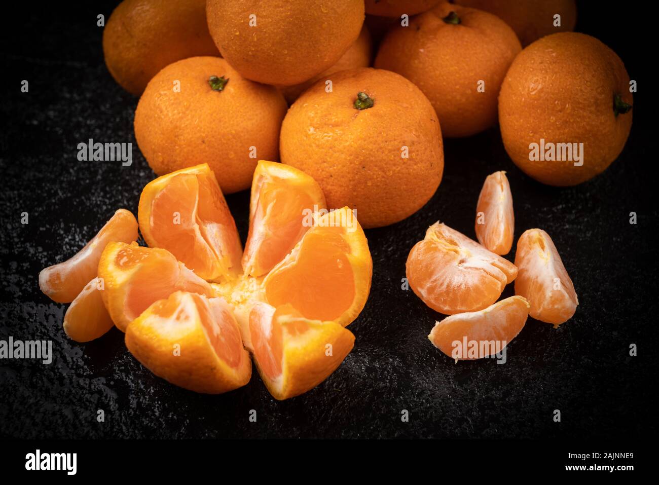 Juicy mandarin on black background. Mandarin Fruit Stock Photo - Alamy