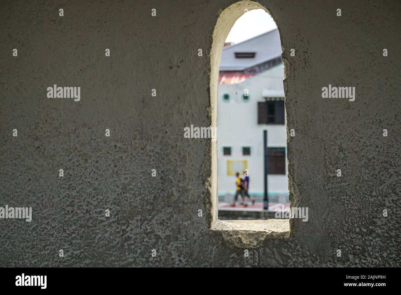 Small window of old brick house with street view in old town of Malacca ...