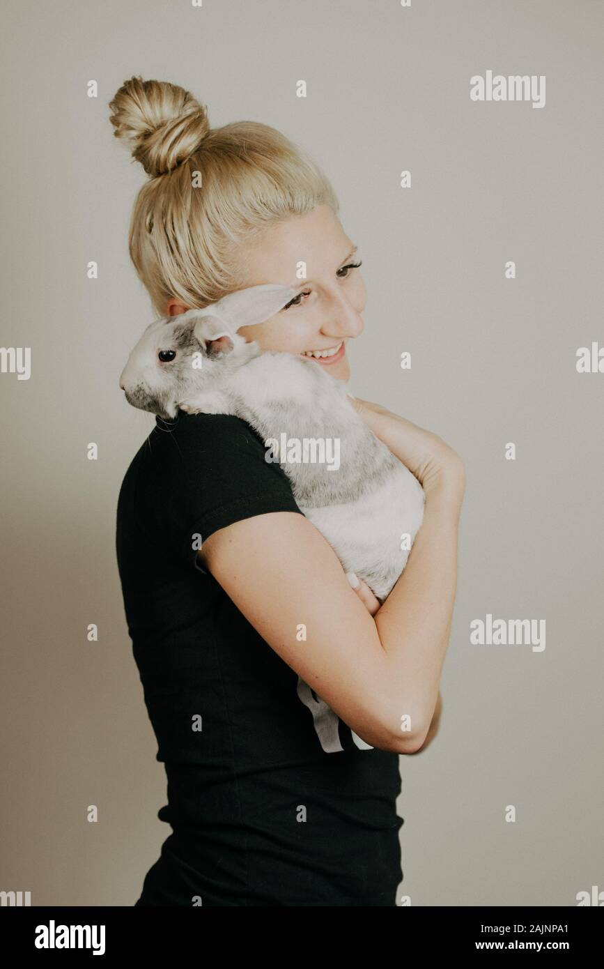Blonde vegan girl with white rabbit wearing shirt that says the future ...
