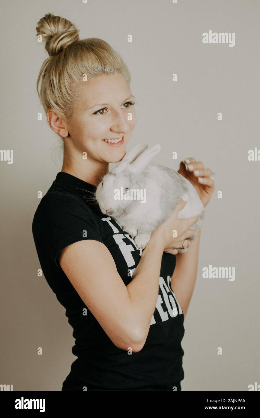 Blonde vegan girl with white rabbit wearing shirt that says the future ...
