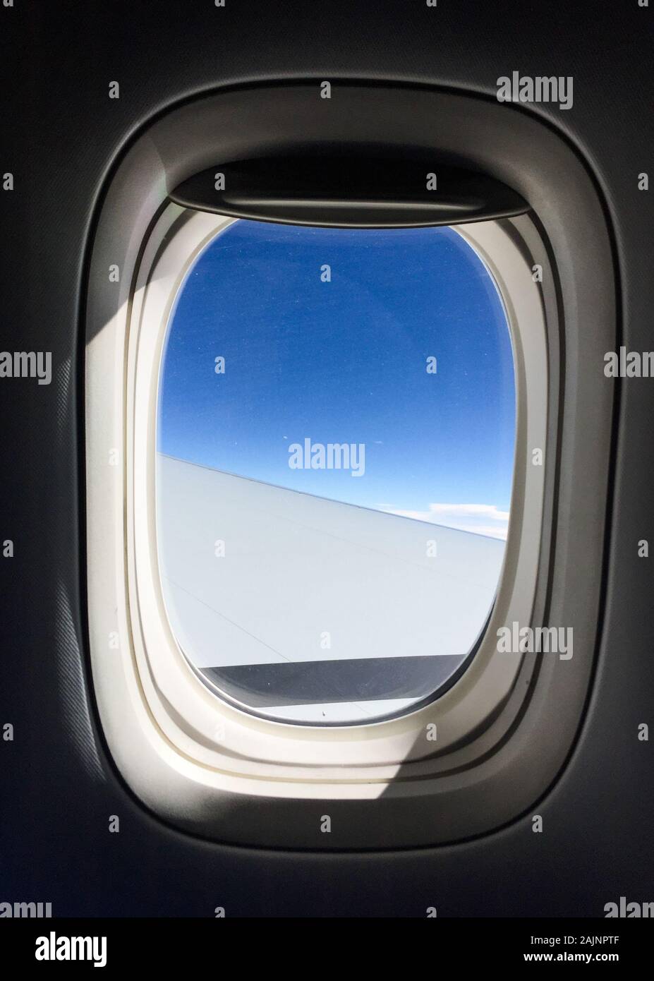 Airplane window with blue sky background. Travel concept Stock Photo ...