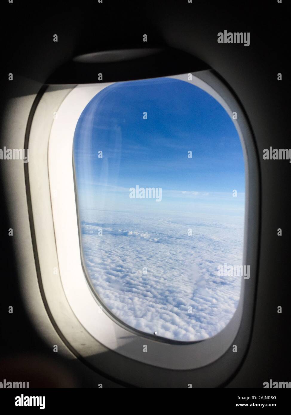 Airplane window with blue sky background. Travel concept Stock Photo ...
