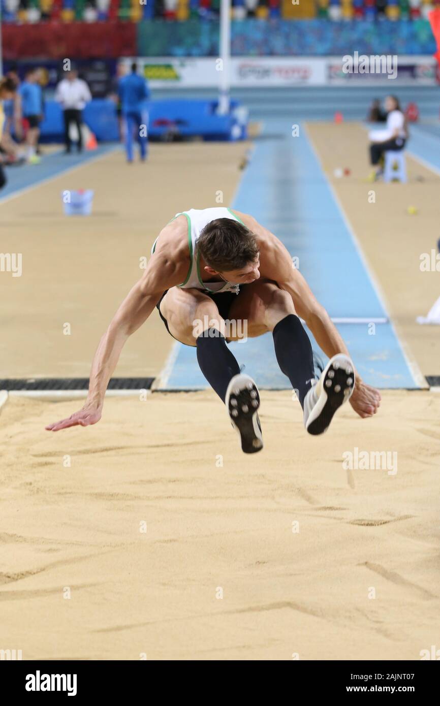 ISTANBUL, TURKEY - DECEMBER 21, 2019: Undefined athlete long jumping ...