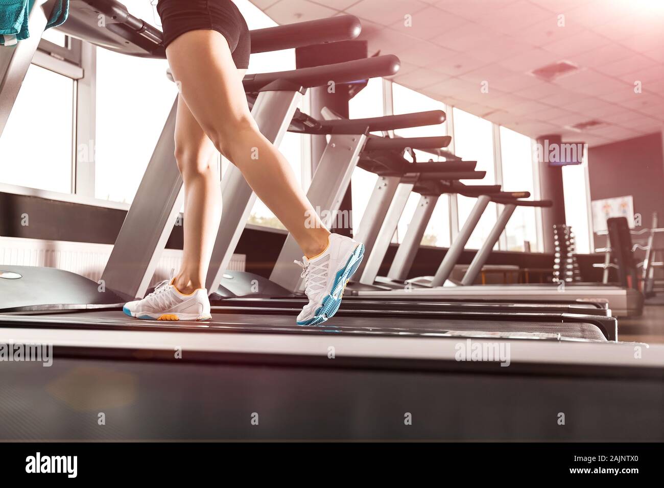 womans legs running at the treadmill in the gym Stock Photo - Alamy