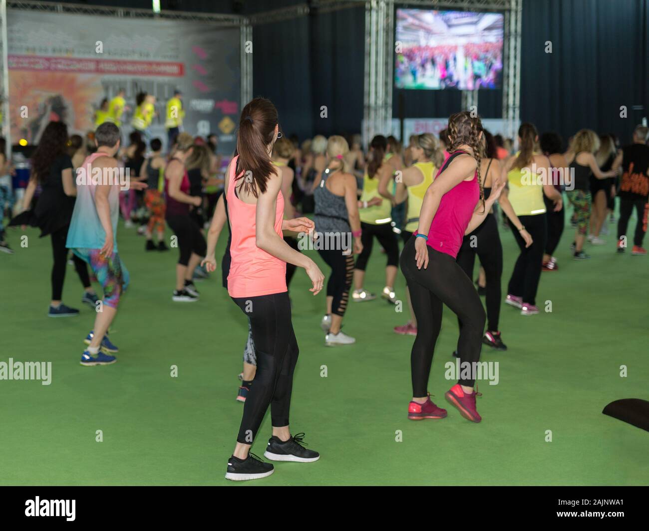 Fitness Workout in Gym: People doing Exercises in Class with Music and ...