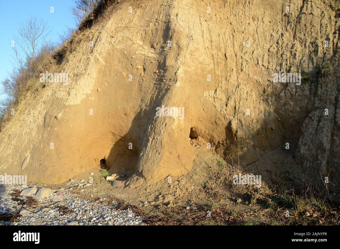 Openings of underground water streams in clay slope Stock Photo - Alamy